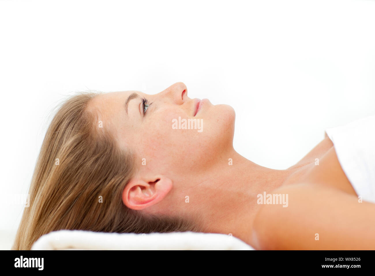Portrait of calm woman relaxing after a spa treatment against a white ...