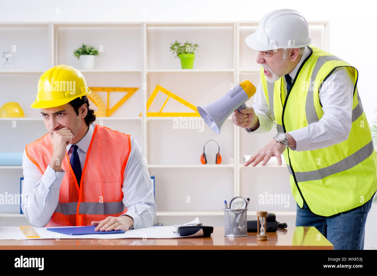 Two engineers colleagues working under project Stock Photo - Alamy