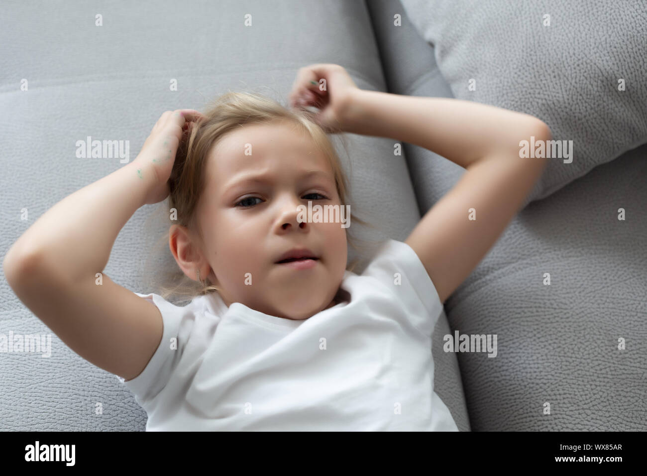 The girl scratches her head, severe itching, infection with lice Stock ...