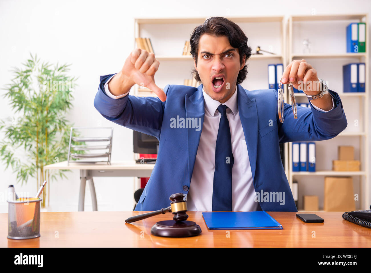 Young handsome judge sitting in courtroom Stock Photo - Alamy