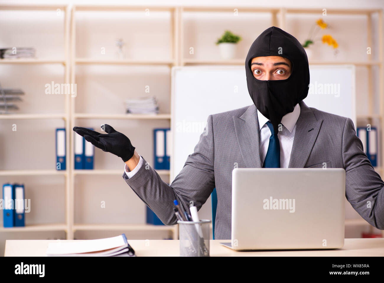 Male gangster stealing information from the office Stock Photo - Alamy