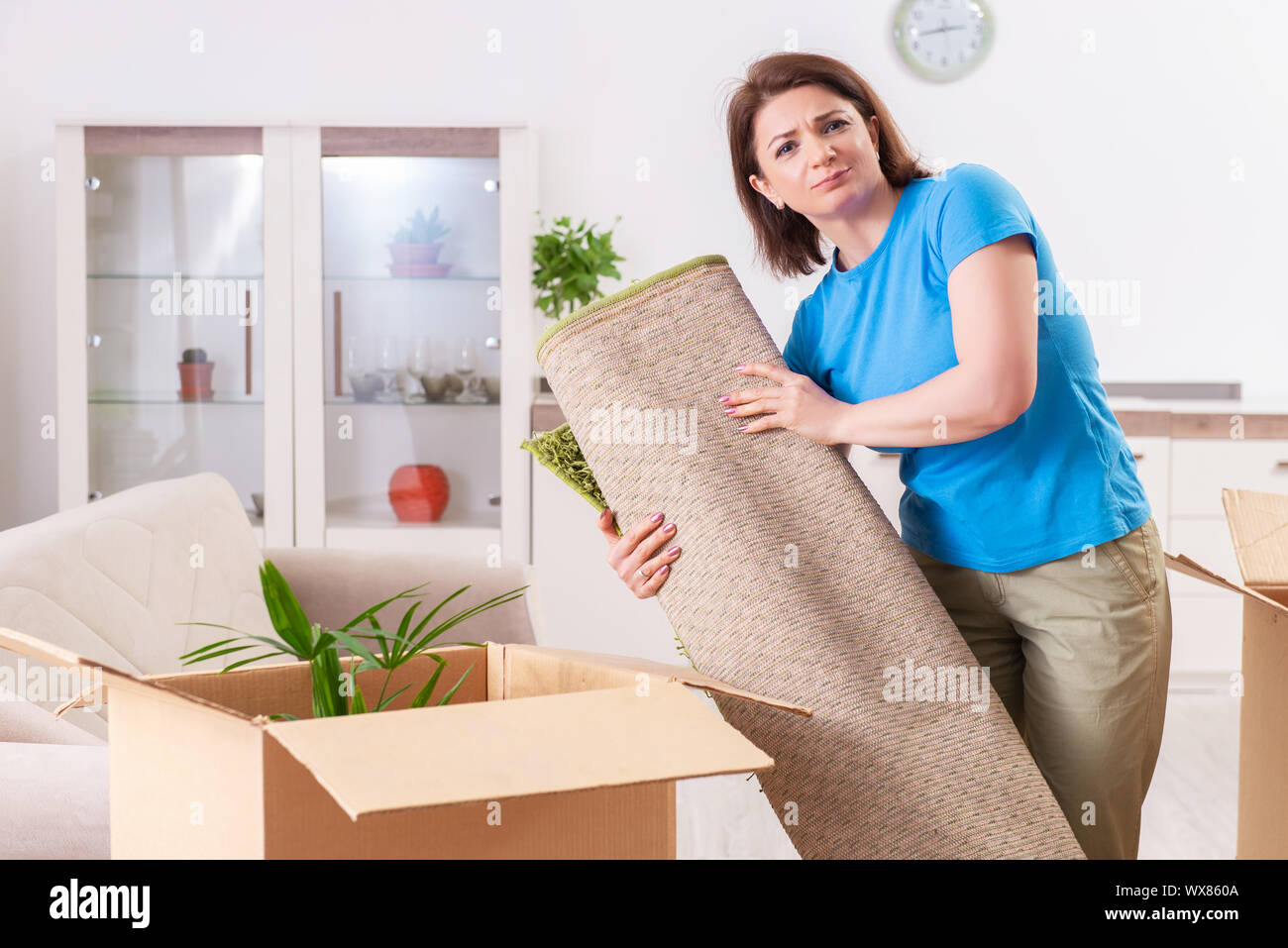 Middle-aged woman moving to new flat Stock Photo - Alamy