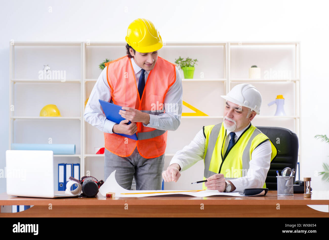 Two engineers colleagues working under project Stock Photo - Alamy