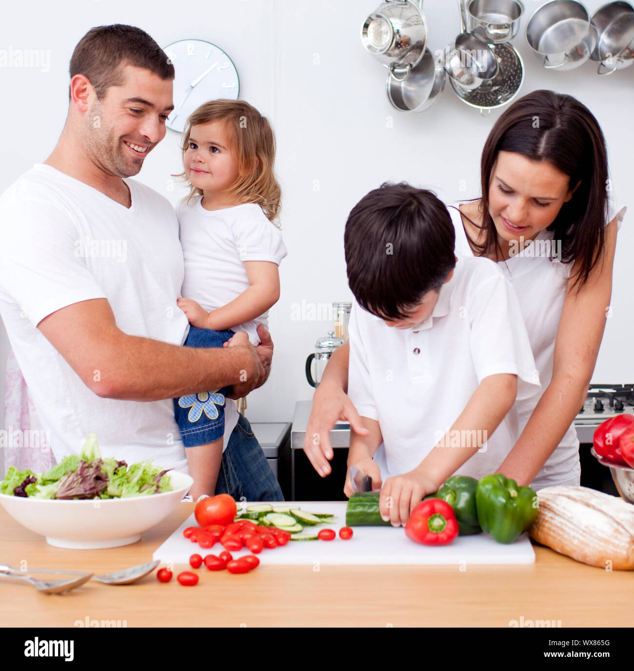 Boy preparing food with his family Stock Photo - Alamy
