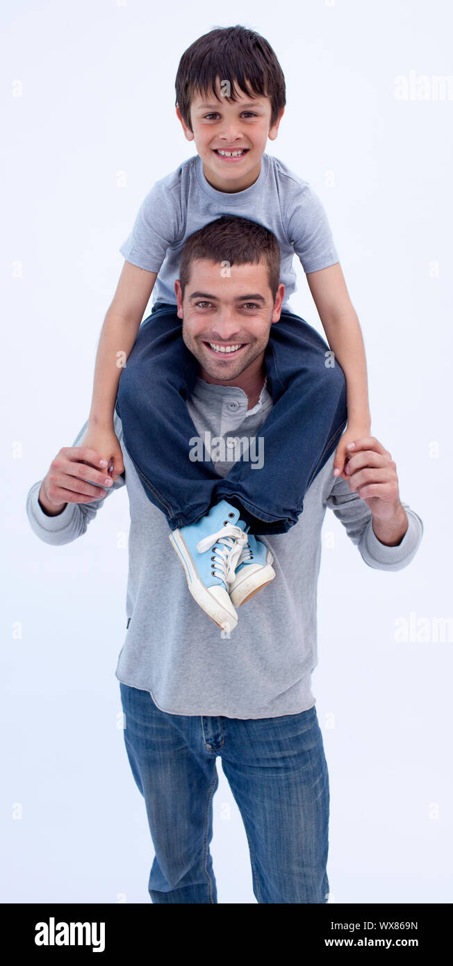 Father giving son piggyback ride against white background Stock Photo - Alamy