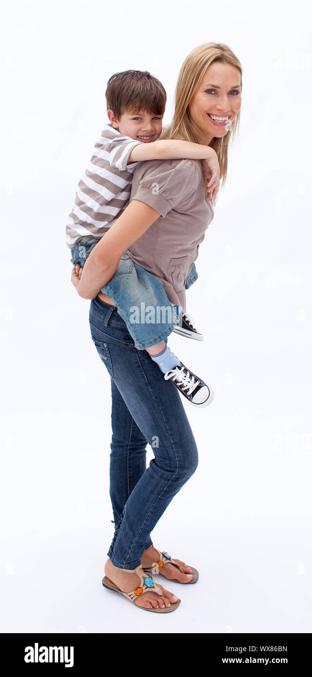 Mother giving son piggy back ride against white background Stock Photo - Alamy