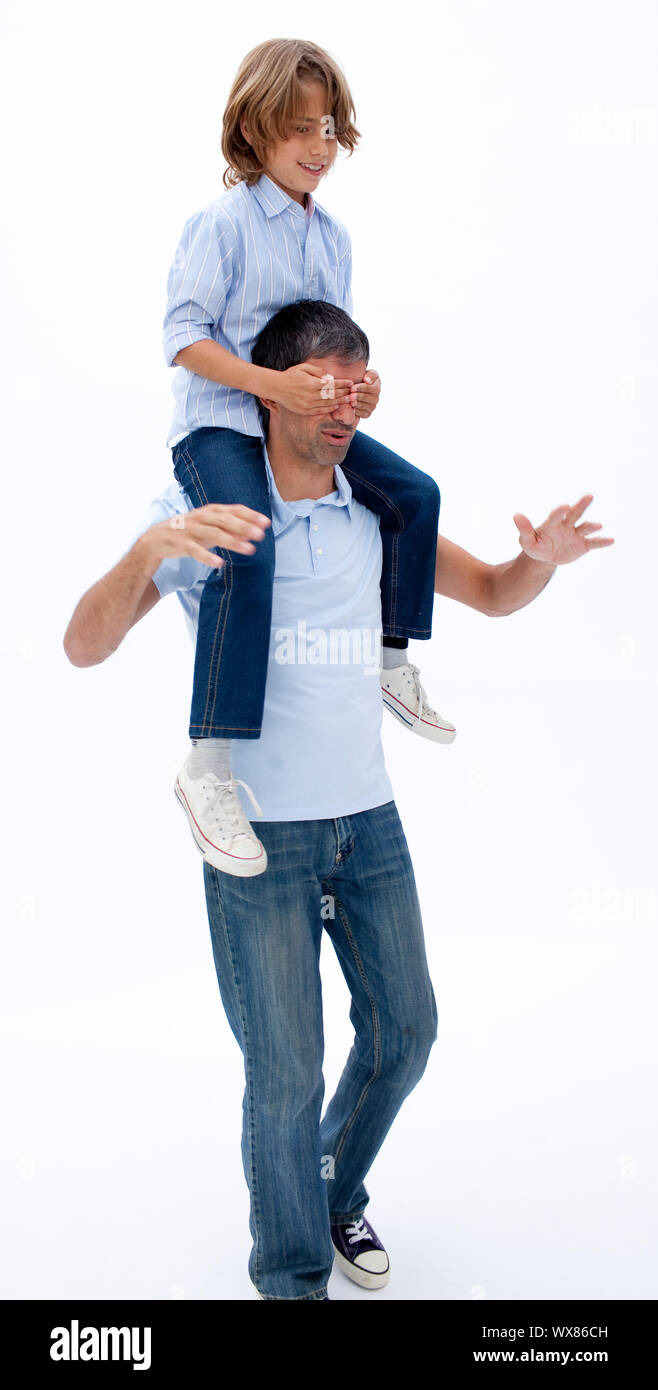 Father giving son piggy back ride with eyes closed against white background Stock Photo - Alamy