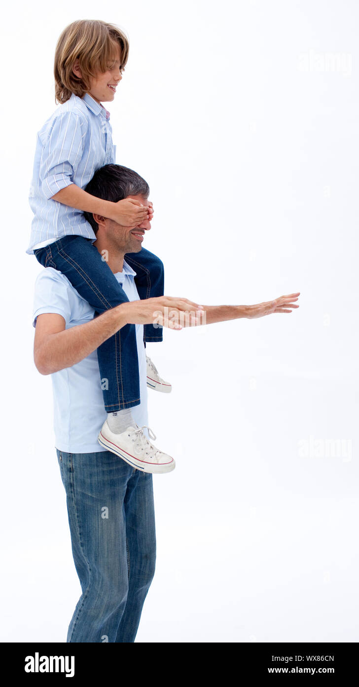 Man giving son piggy back ride with eyes closed against white background Stock Photo - Alamy