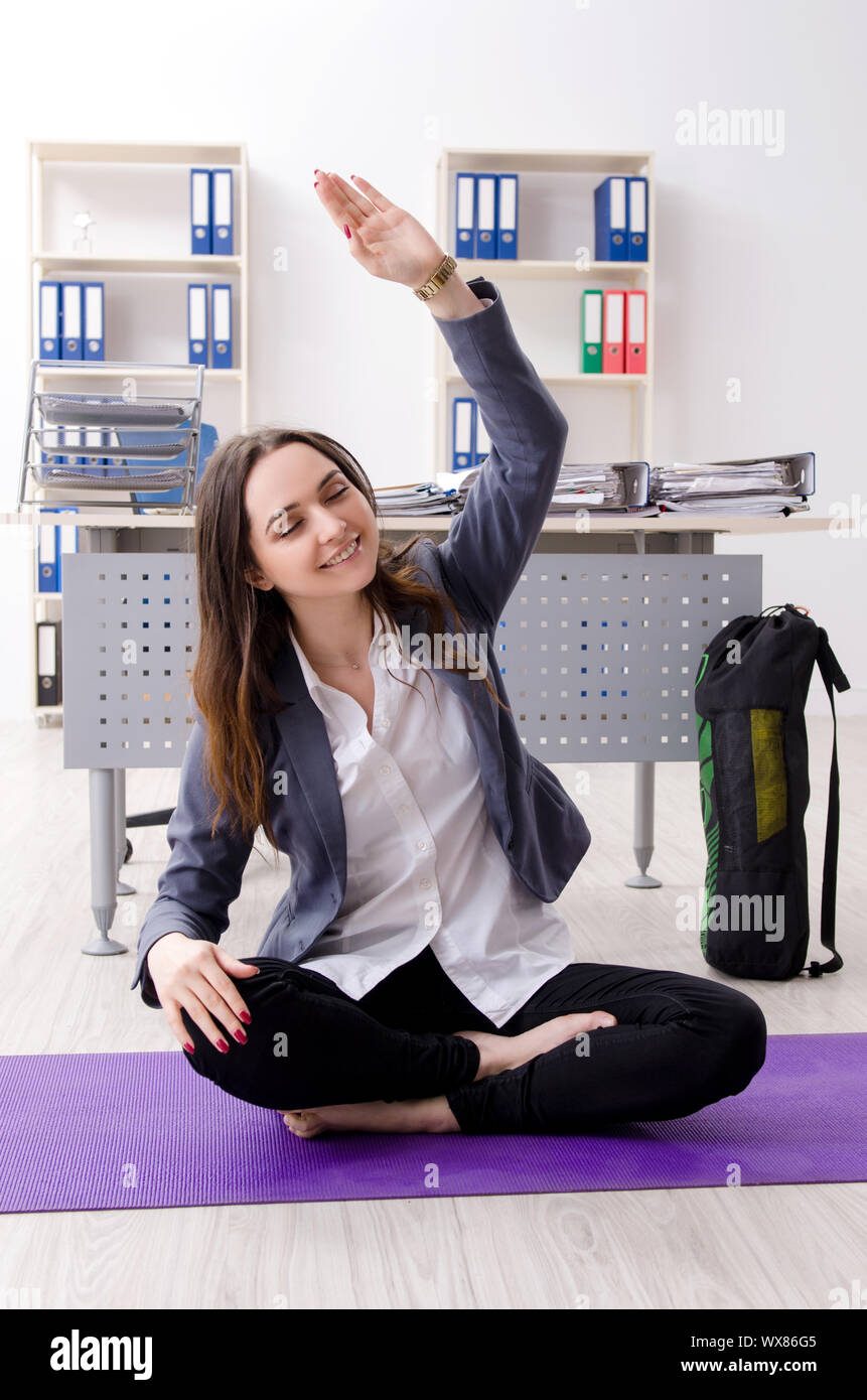 Female employee doing sport exercises in the office Stock Photo - Alamy
