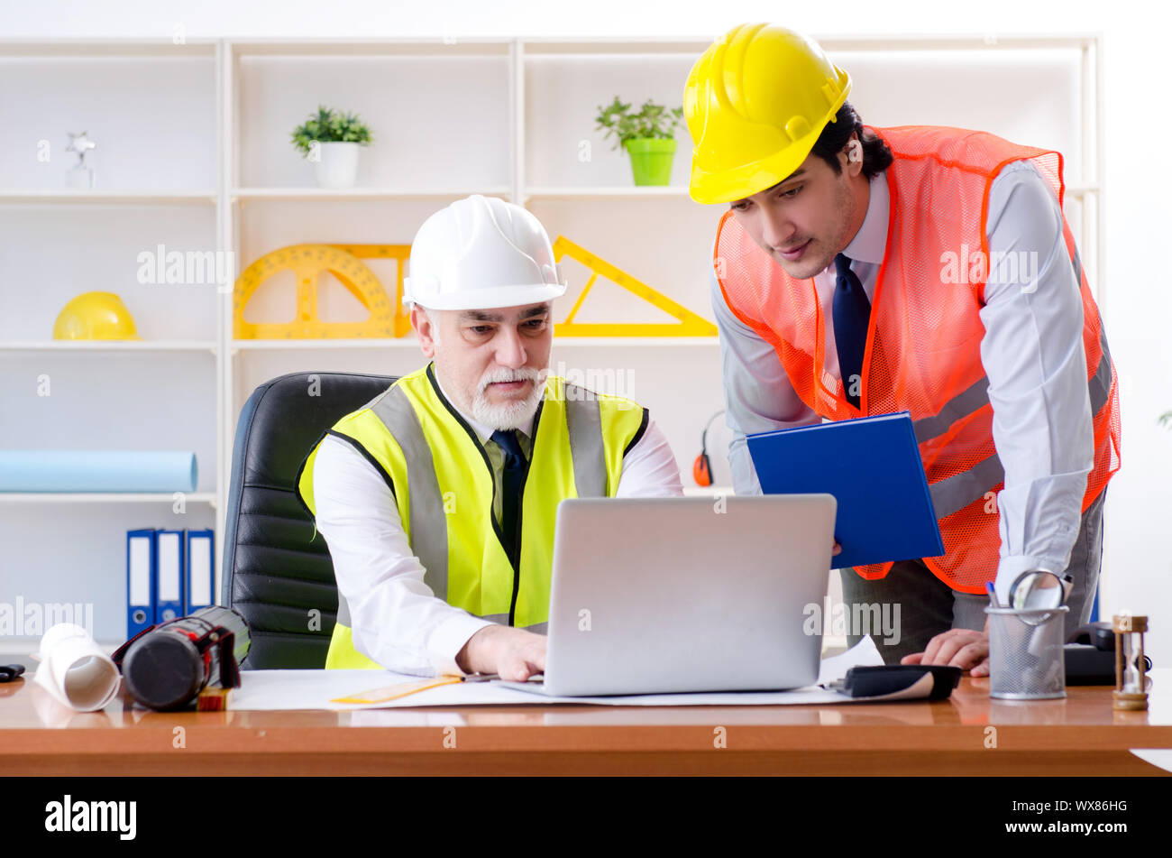 Two engineers colleagues working under project Stock Photo - Alamy