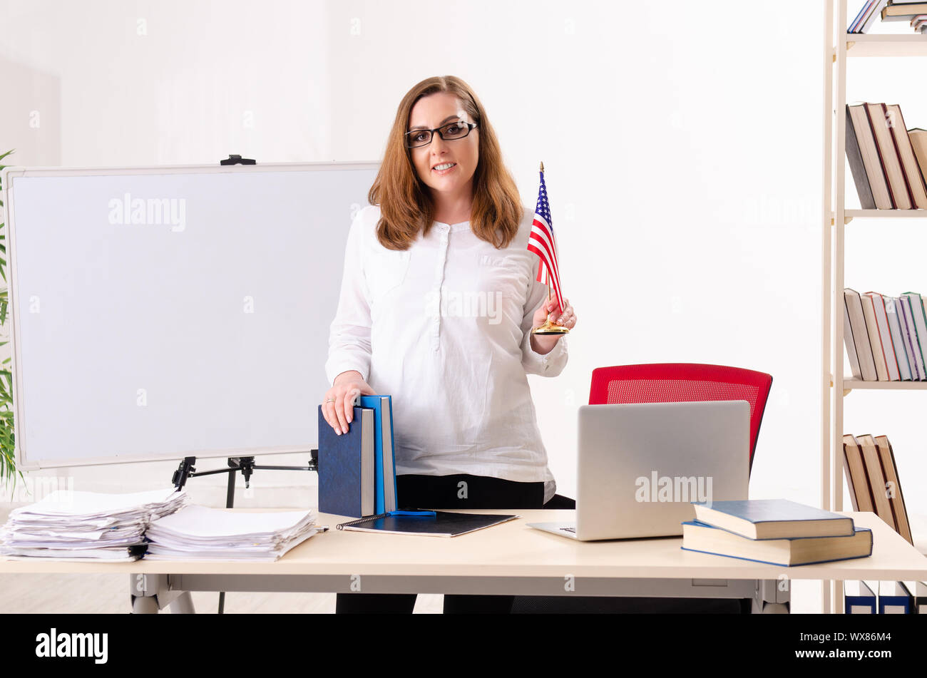 Female english teacher in the classroom Stock Photo - Alamy