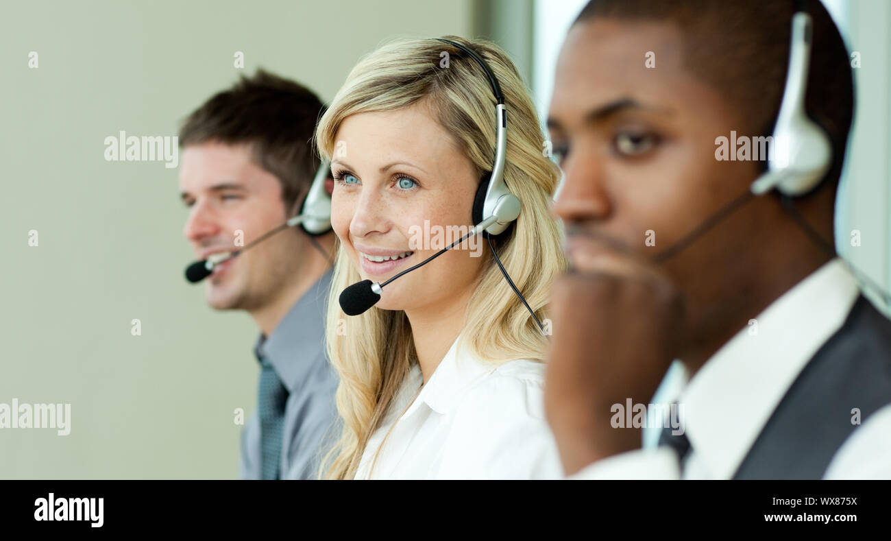 Three business people working in the office with headsets Stock Photo ...