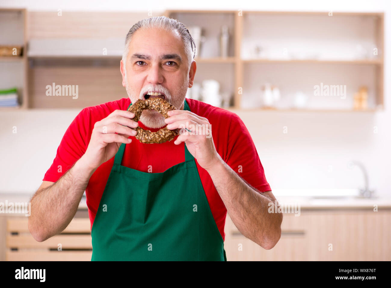 Old male baker working in the kitchen Stock Photo - Alamy