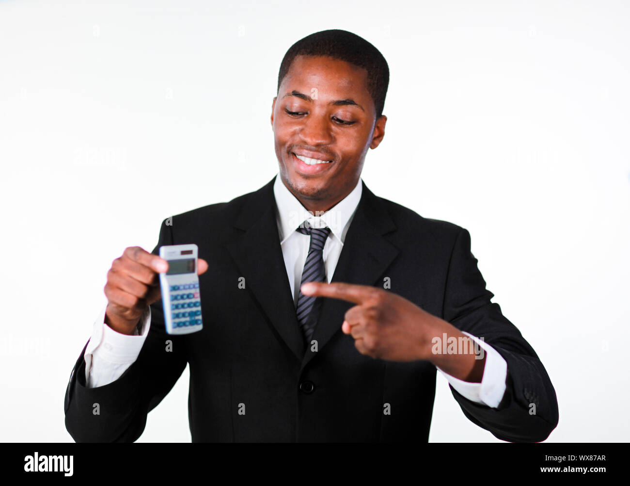 Portrait of an African businessman showing a calculator and smiling at ...