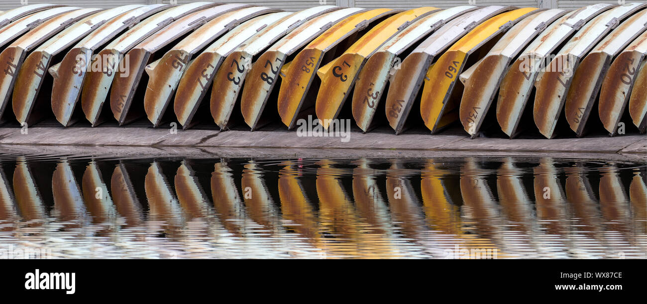 Row boats stacked at boat shed Stock Photo - Alamy