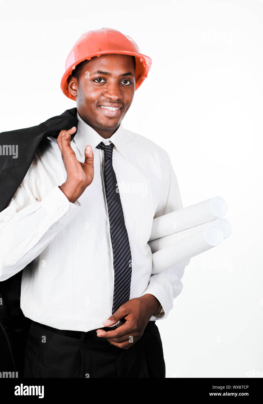 Ethnic architect holding blueprints and standing in front of the camera ...