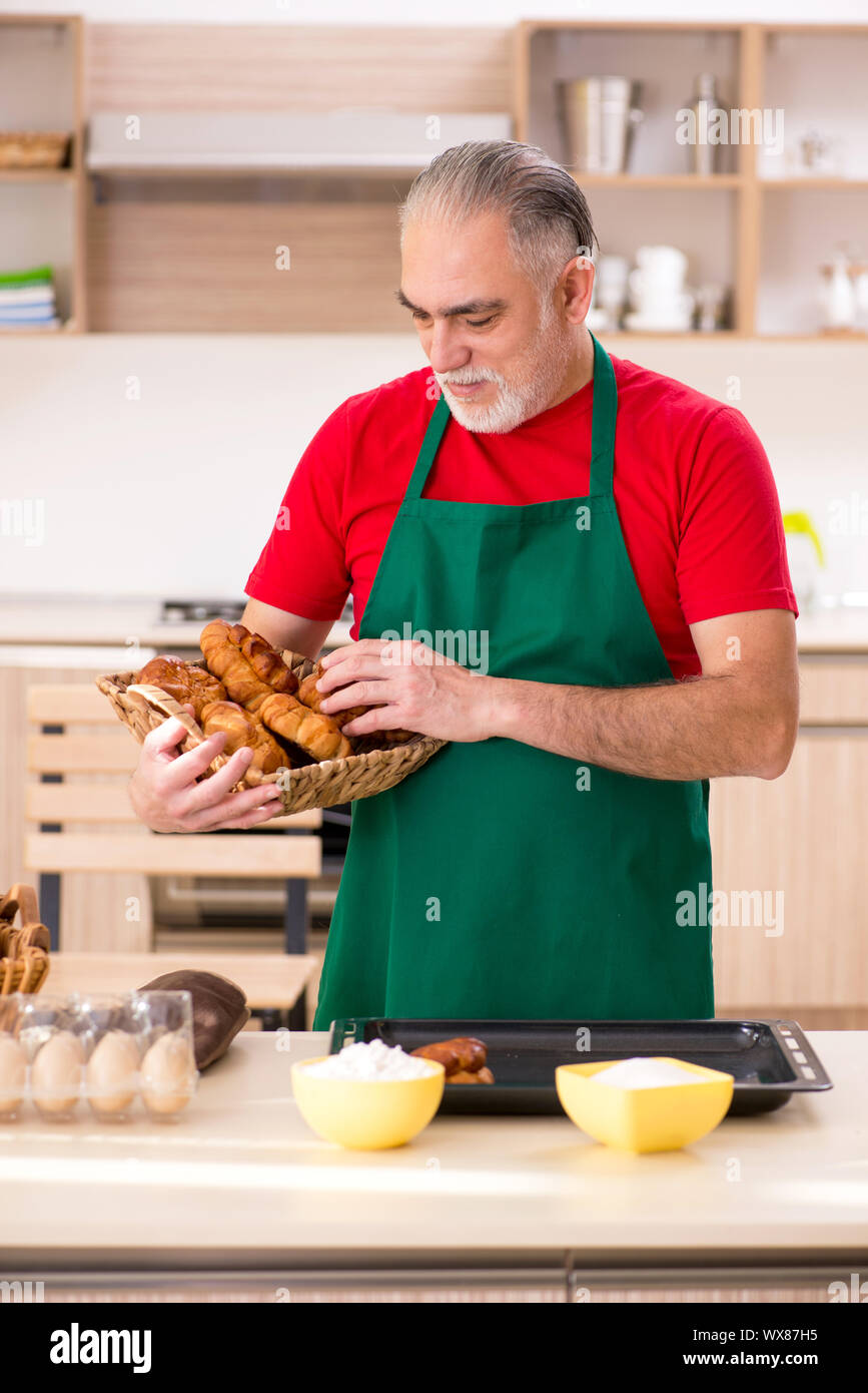 Old male baker working in the kitchen Stock Photo - Alamy