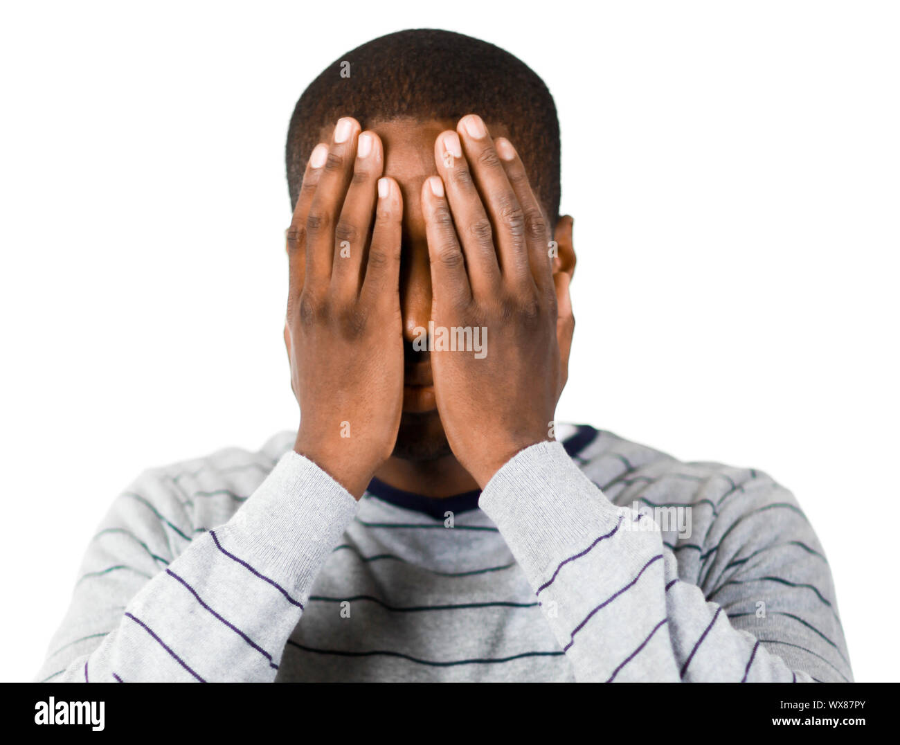 Young man covering his face in despair Stock Photo - Alamy