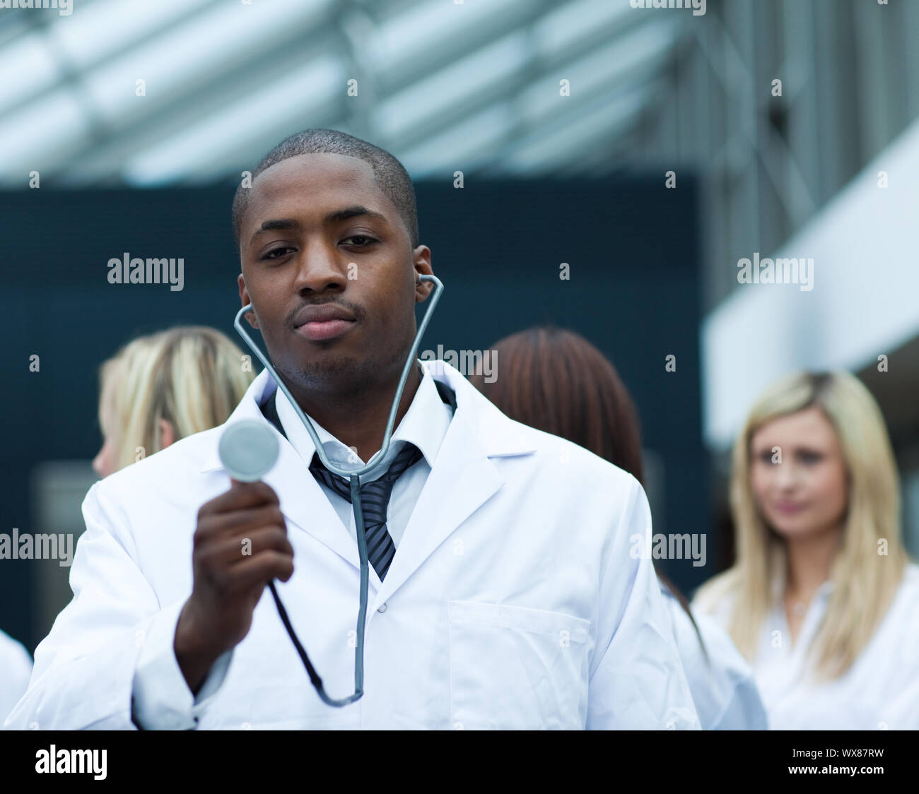 Handsome Afro-American leading his team and looking at the camera Stock ...