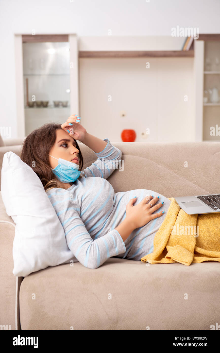 Sick pregnant woman suffering at home Stock Photo - Alamy