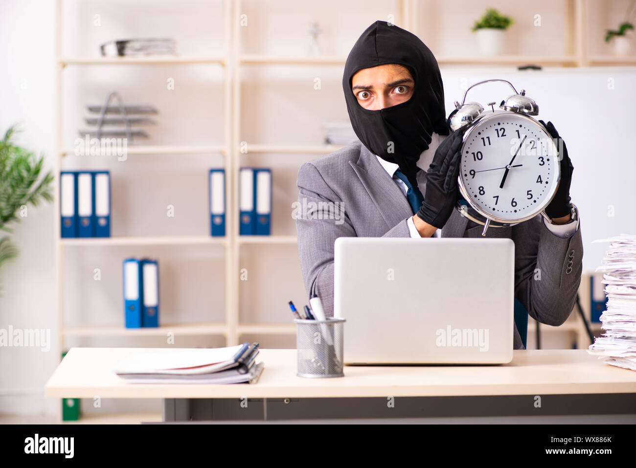 Male gangster stealing information from the office Stock Photo - Alamy