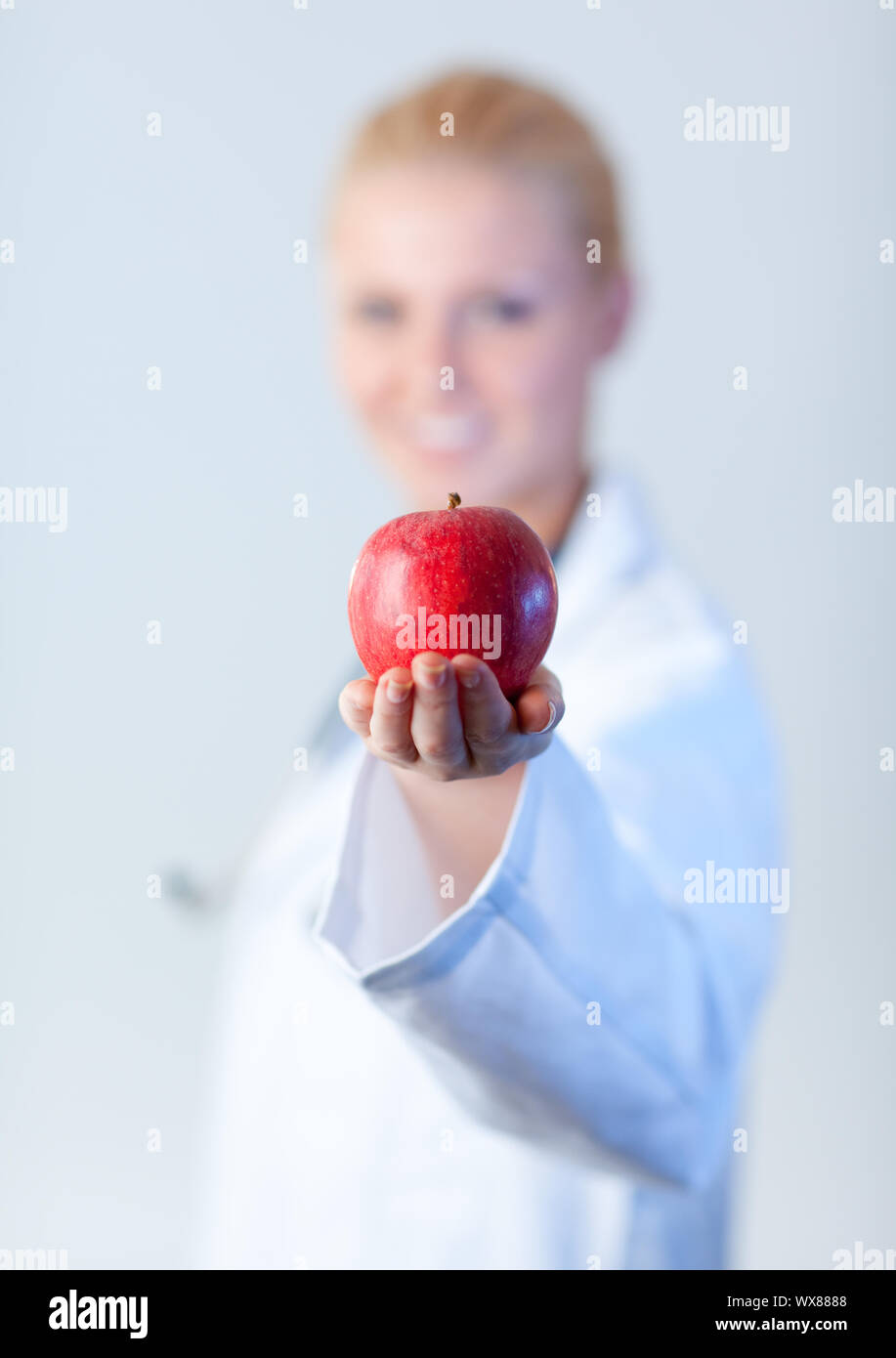 Doctor holding an apple with focus on the apple Stock Photo - Alamy