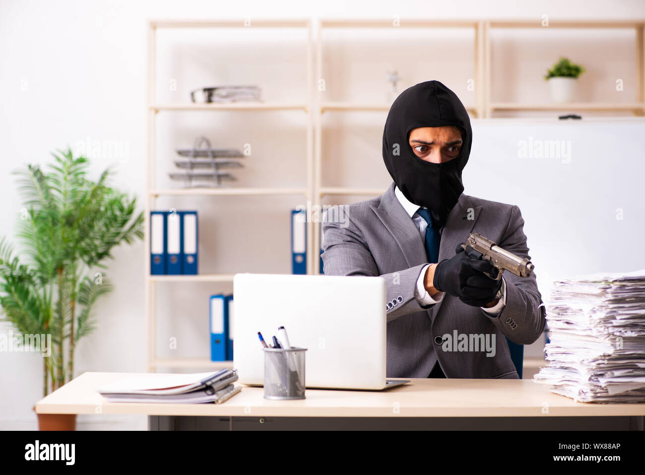 Male gangster stealing information from the office Stock Photo - Alamy