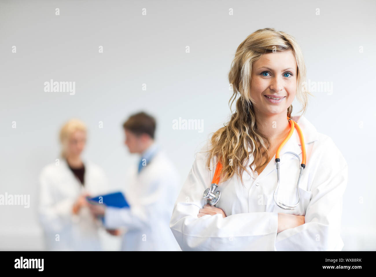 Pretty female surgeon with her team behind her Stock Photo - Alamy