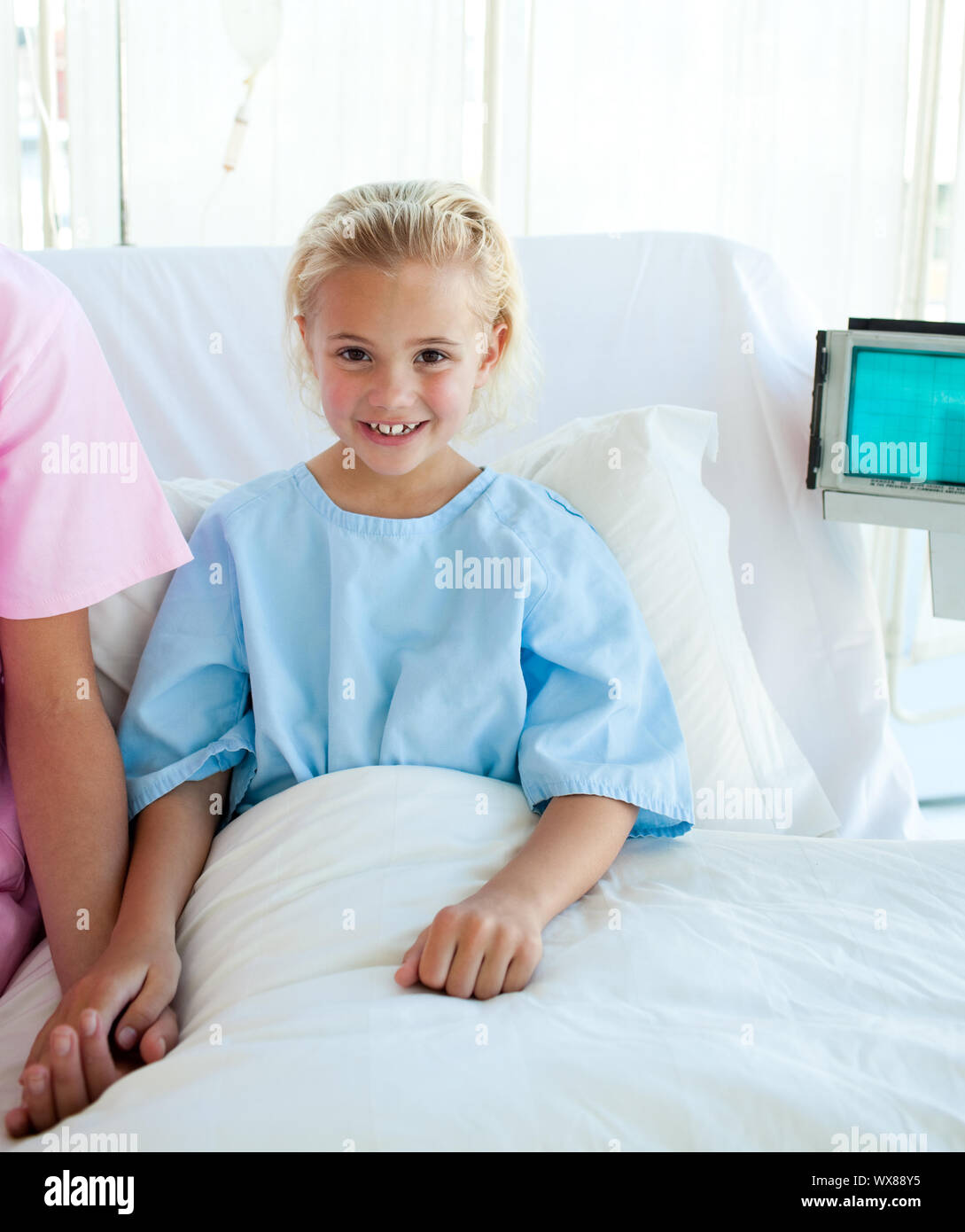 Portrait of a sick little girl on a hospital bed Stock Photo - Alamy