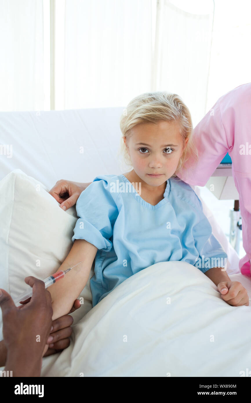 Upset child patient receiving an injection in a hospital Stock Photo ...
