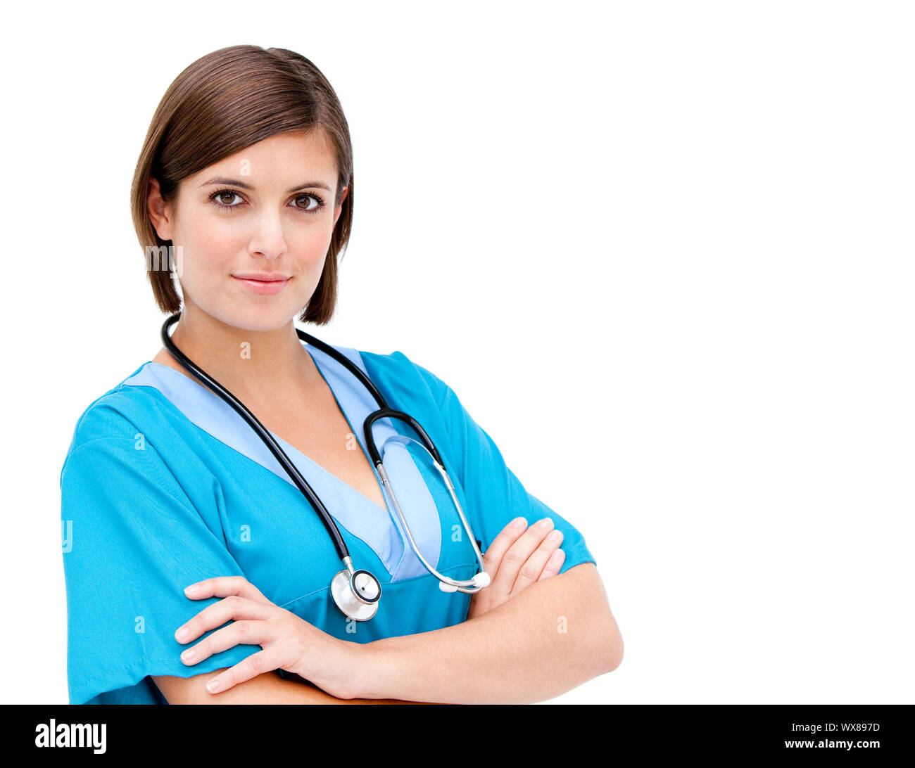 Self-assured female doctor folding arms against white background Stock Photo - Alamy