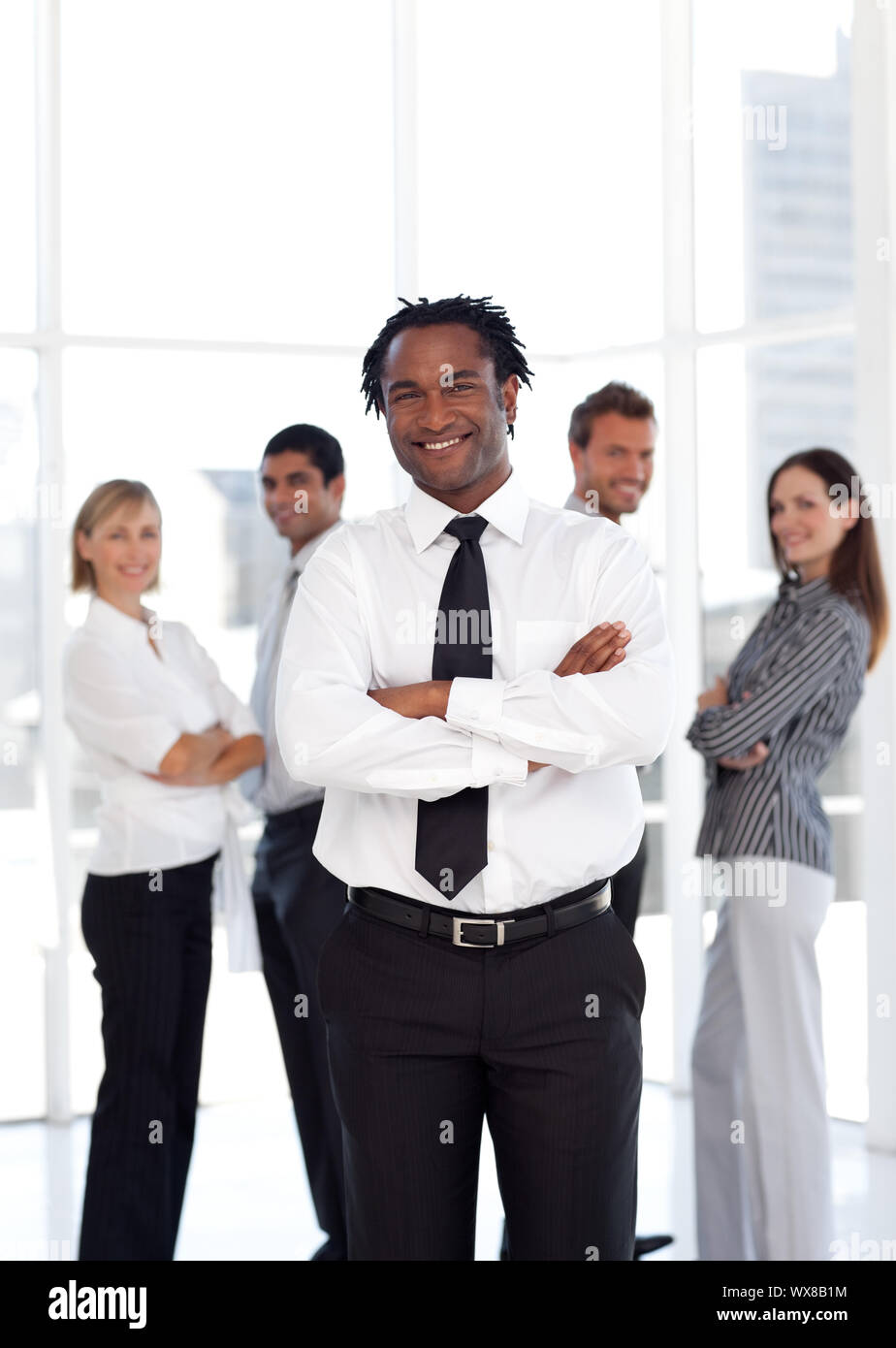 Portrait of a male leader with his team in background Stock Photo - Alamy