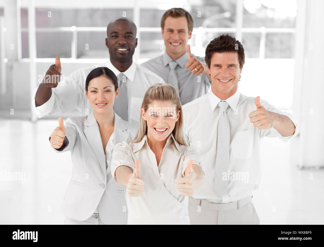 Positive Business Team Smiling and Holding up Thumbs to camera Stock ...