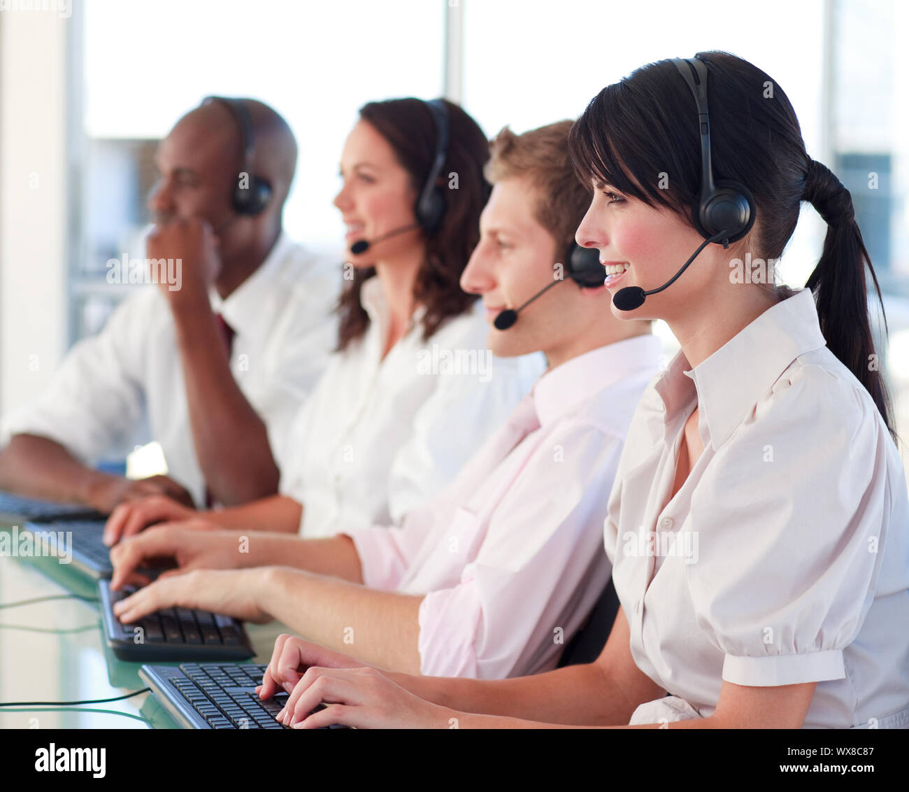 Happy people working in an office Stock Photo - Alamy