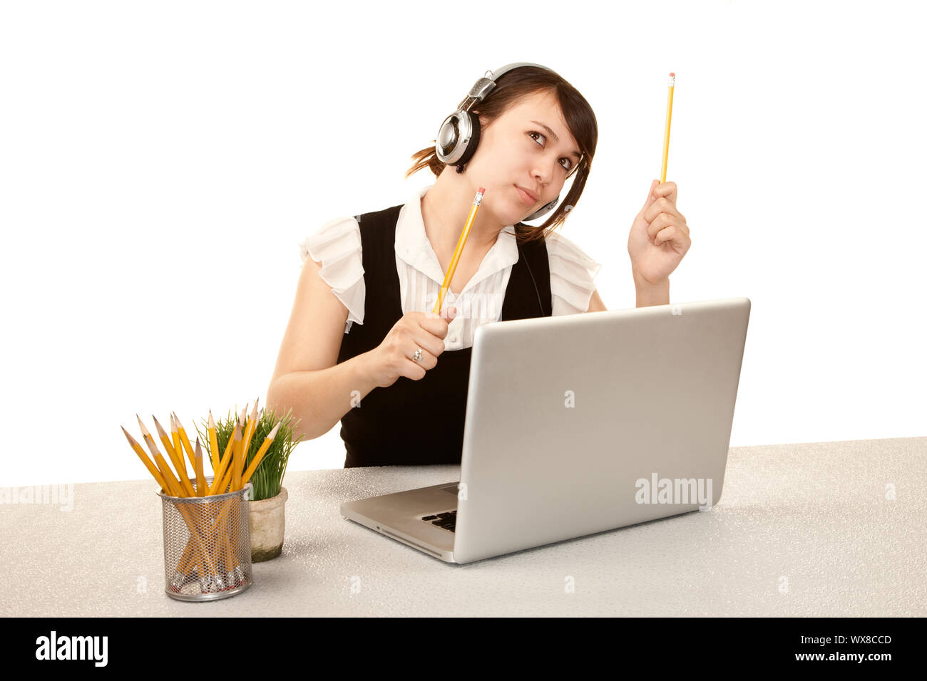 Pretty female office worker with laptop computer and headphones Stock ...