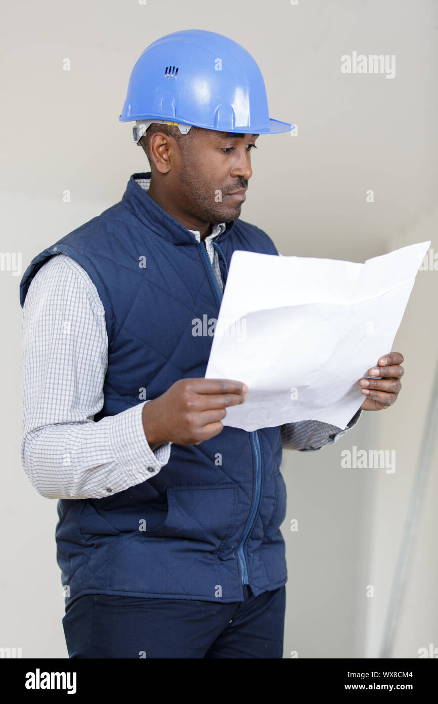 builder reading a map Stock Photo - Alamy