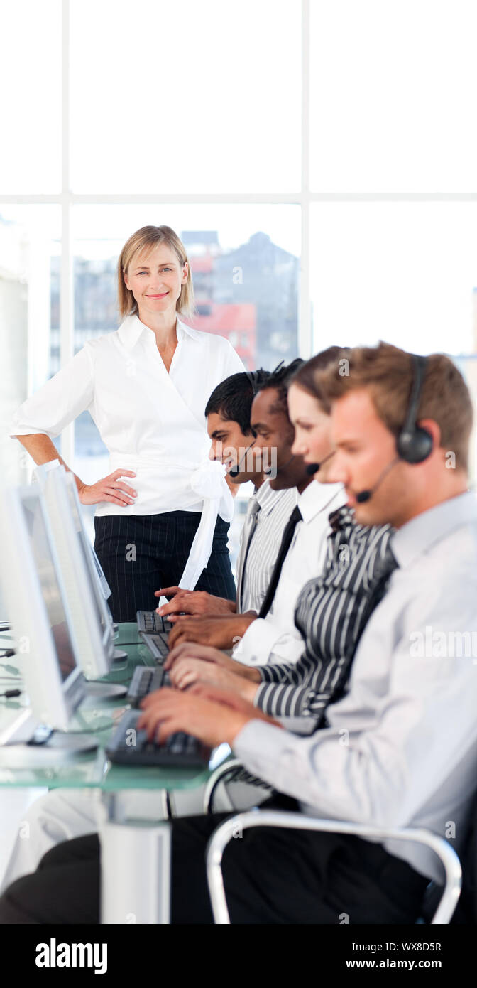 Female leader managing her team in a call center Stock Photo - Alamy