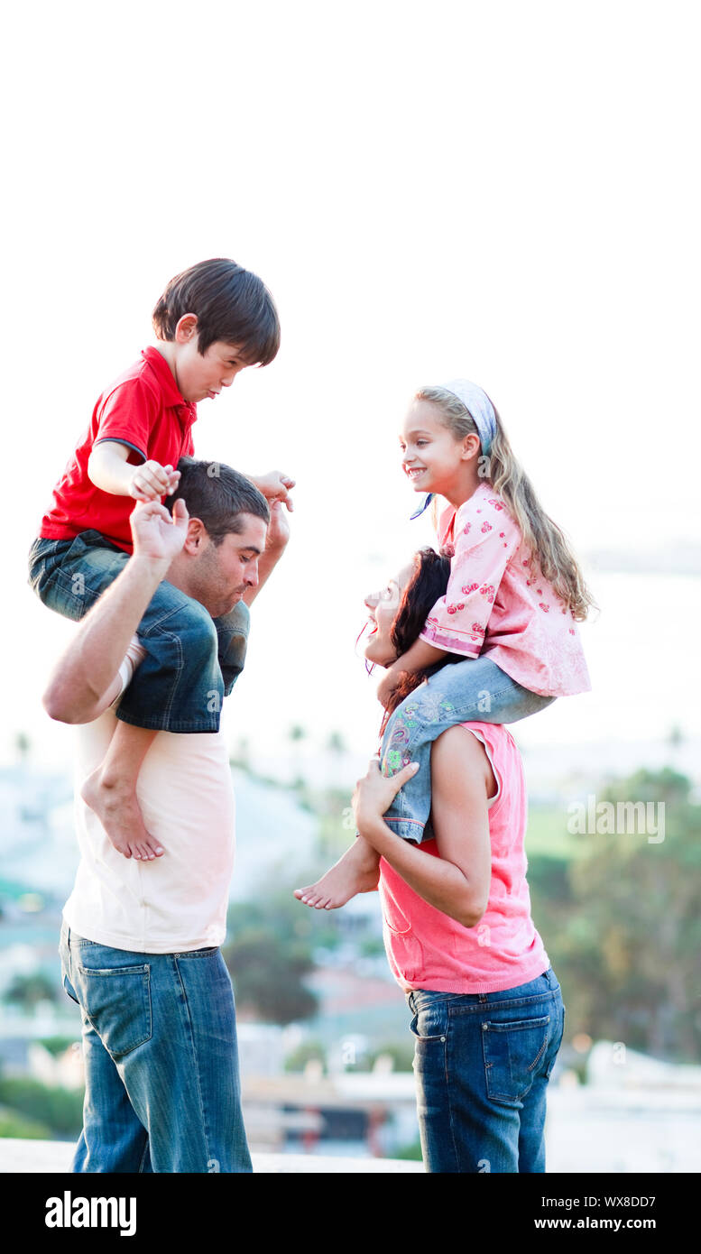 Couple giving piggyback ride children hi-res stock photography and ...