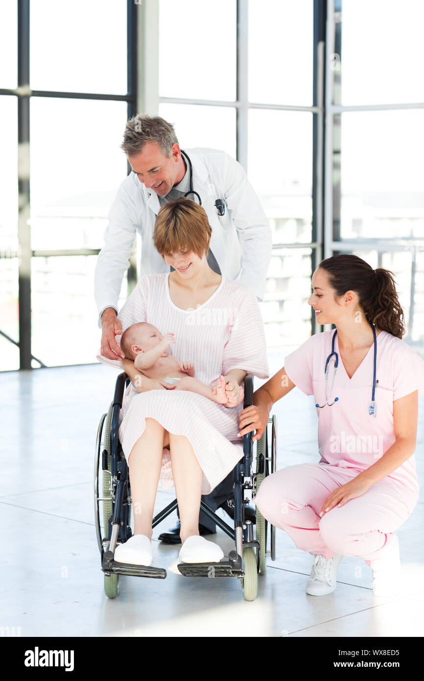 Doctors helping patient and newborn baby in hospital Stock Photo - Alamy