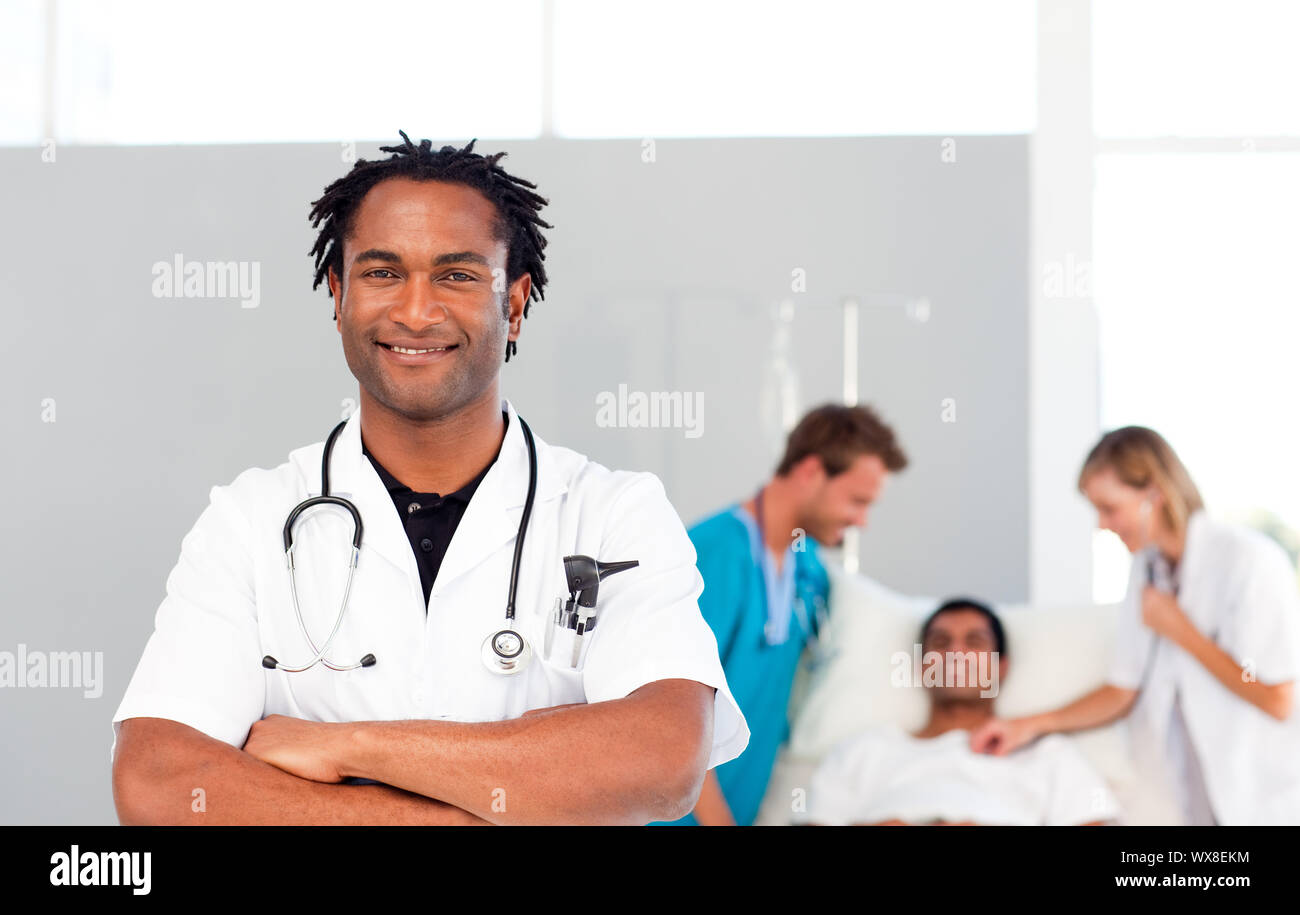 International doctors attending to a patient in a hospital Stock Photo ...