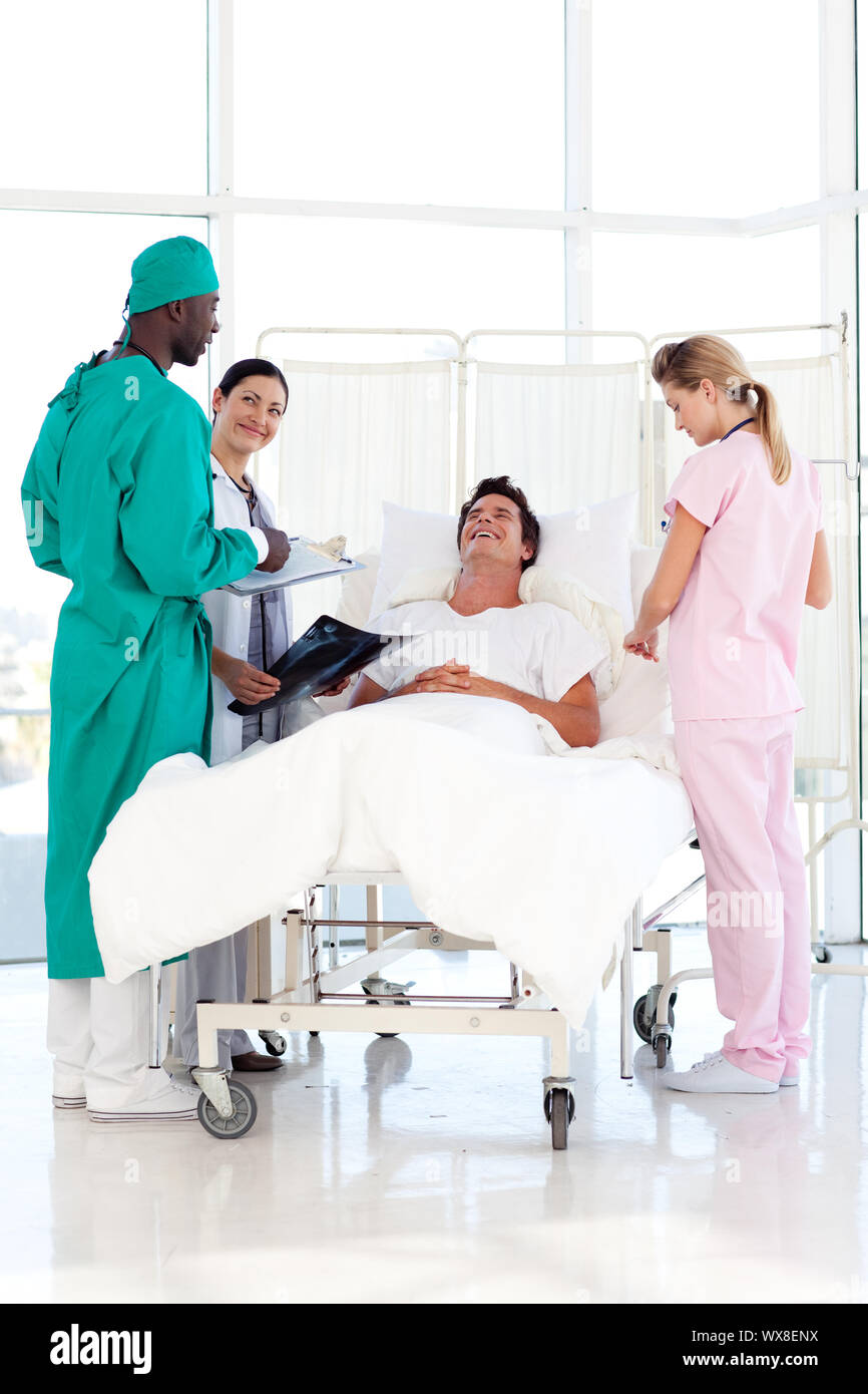 Group of doctors looking after a patient Stock Photo - Alamy