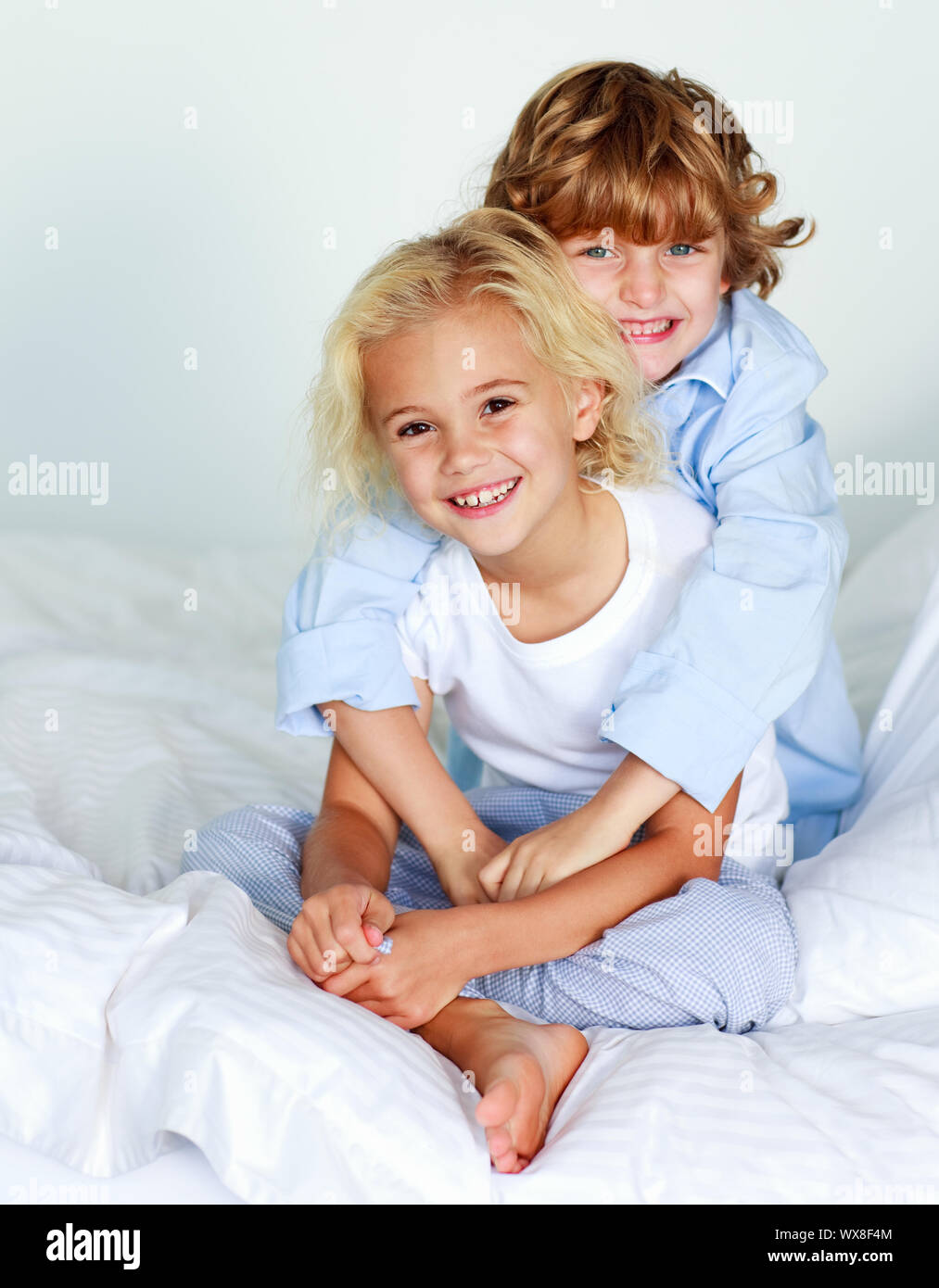 Children waking up together in bed Stock Photo - Alamy