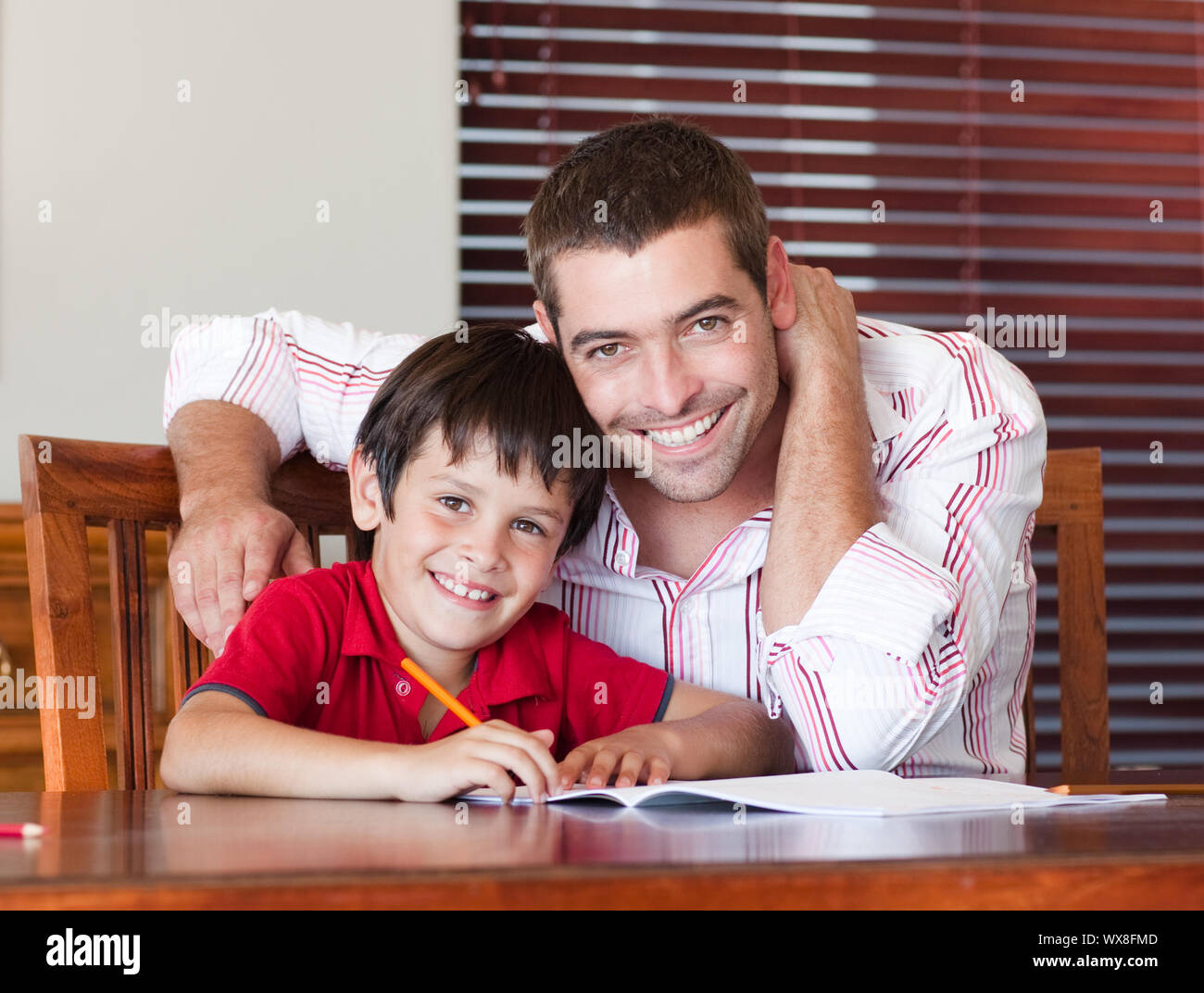 Father with his son looking at the camera Stock Photo - Alamy