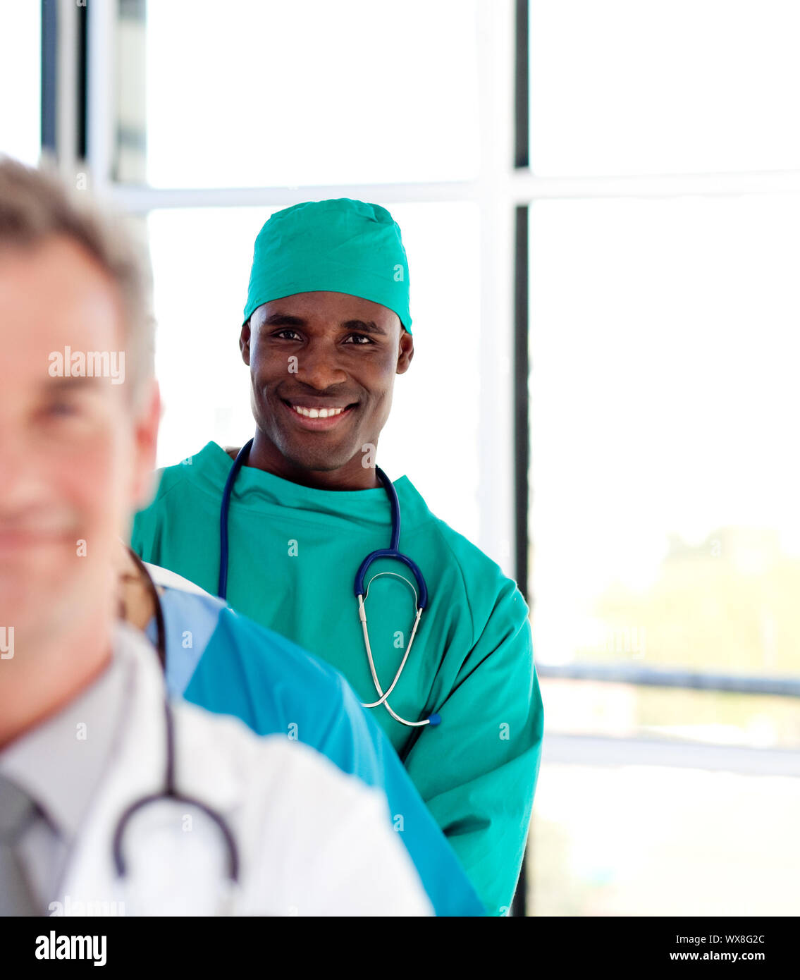 Happy surgeon smiling at the camera in a row Stock Photo - Alamy