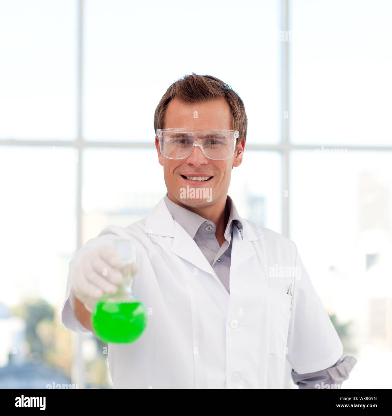 Scientist showing a test-tube in a laboratory Stock Photo - Alamy