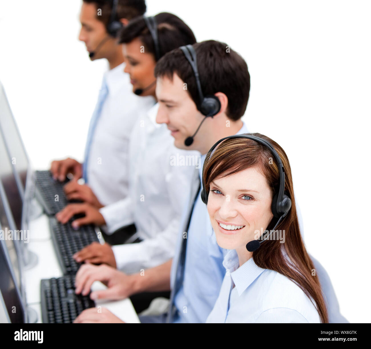 Concentrated business team with headset on against white background ...