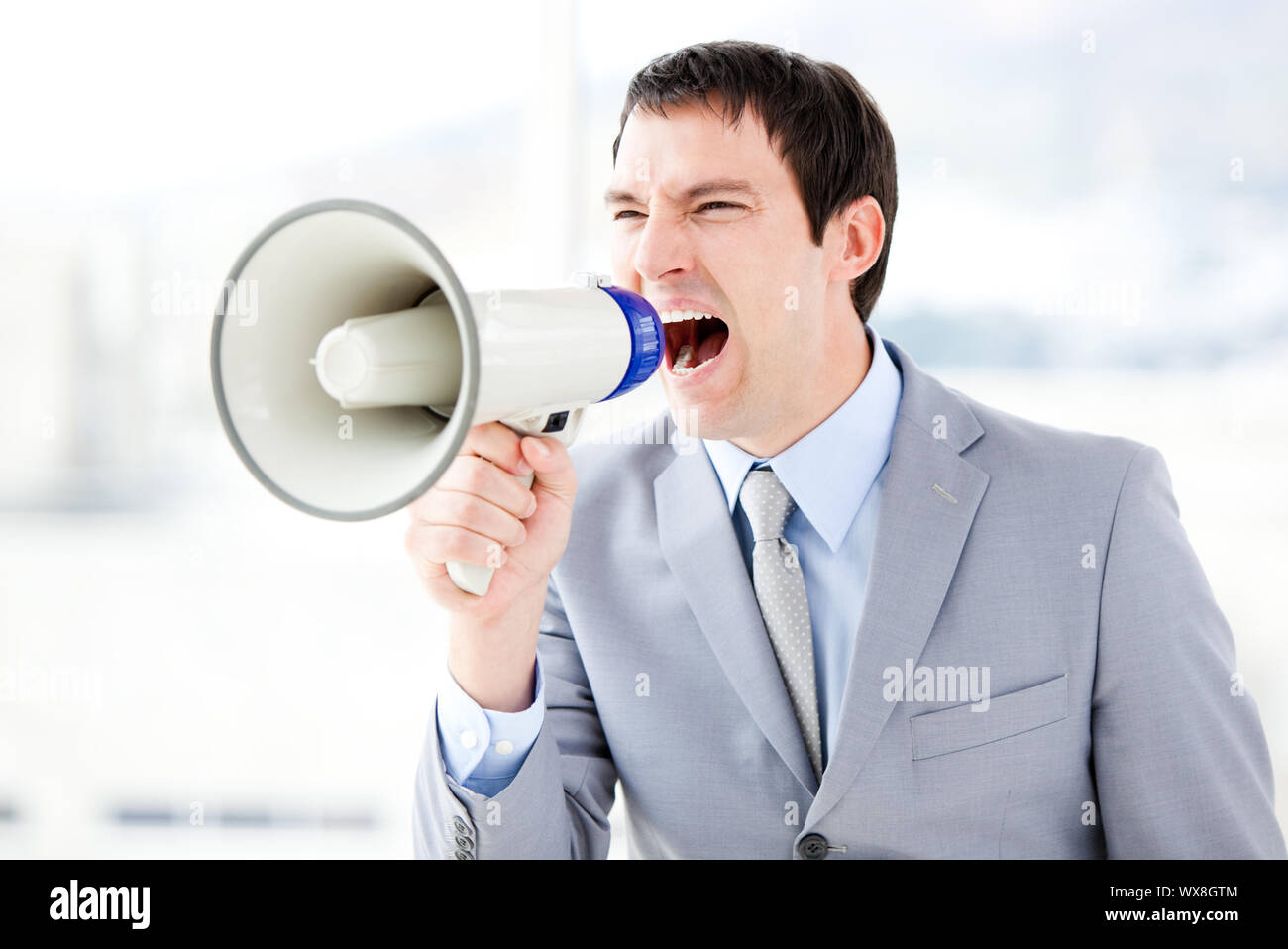 Portrait of an angry businessman using a megaphone in the office Stock ...