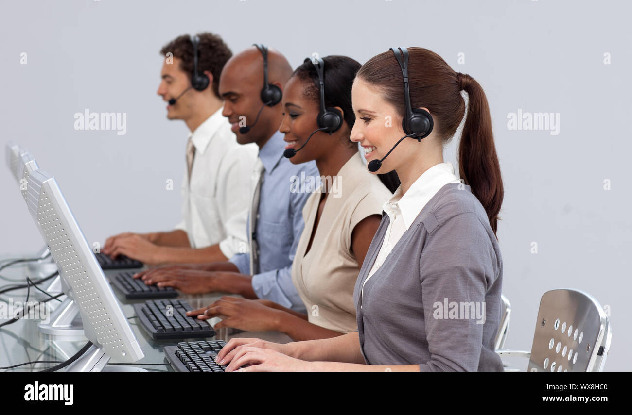 Positive business partners with headset on working in a call center ...