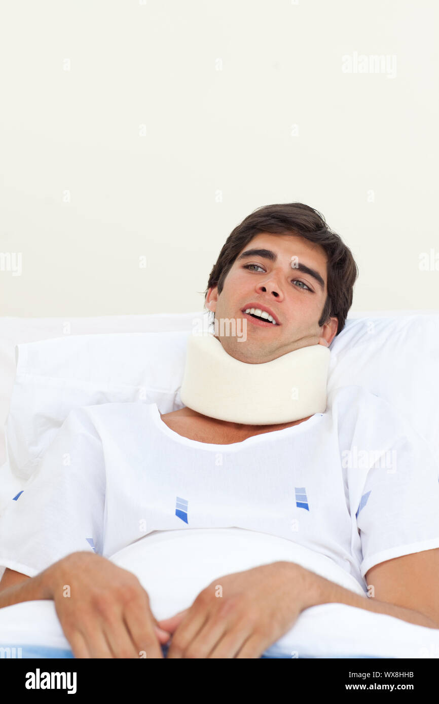 Young patient with a neck brace lying on a hospital bed Stock Photo - Alamy