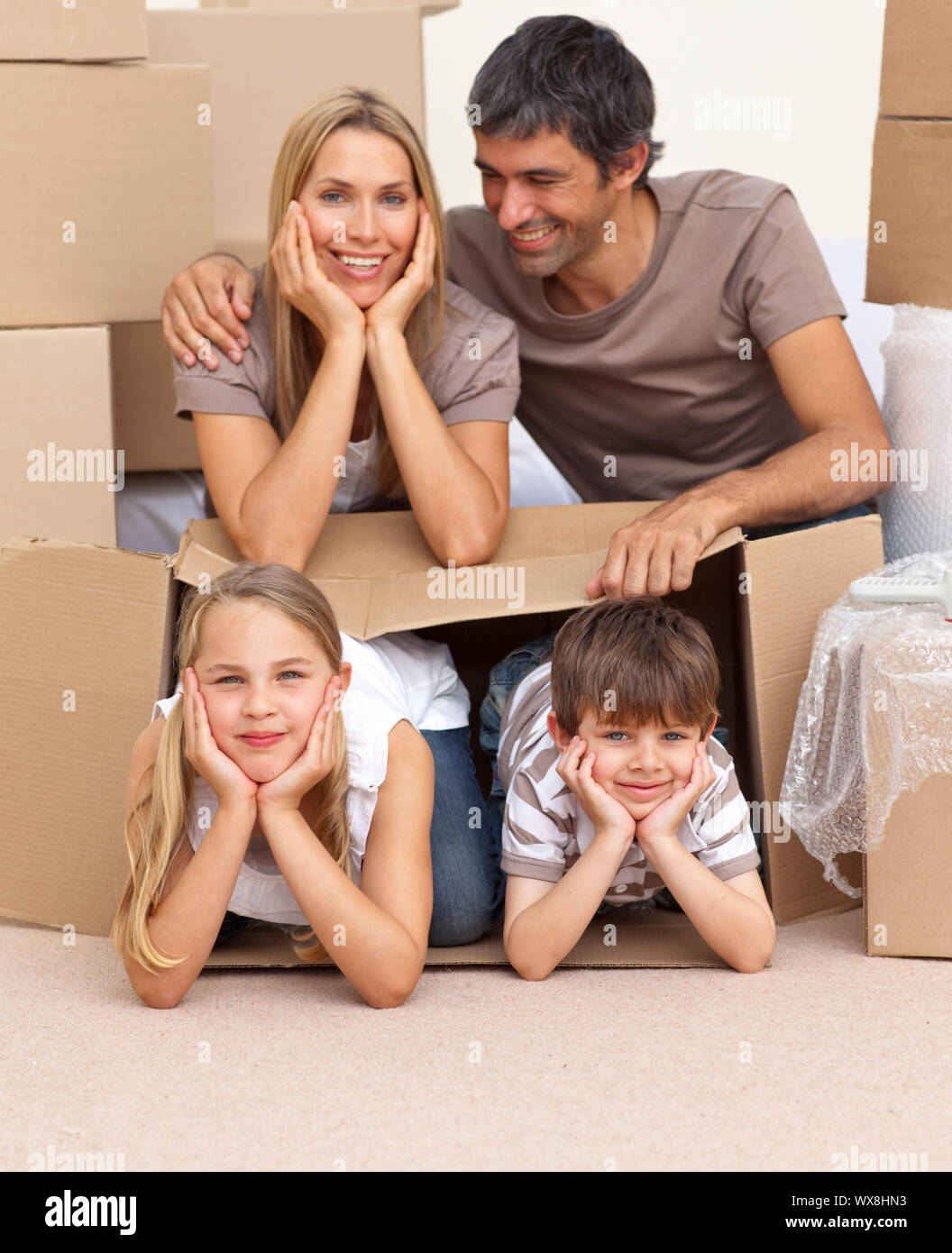 Happy family moving house playing with boxes Stock Photo - Alamy